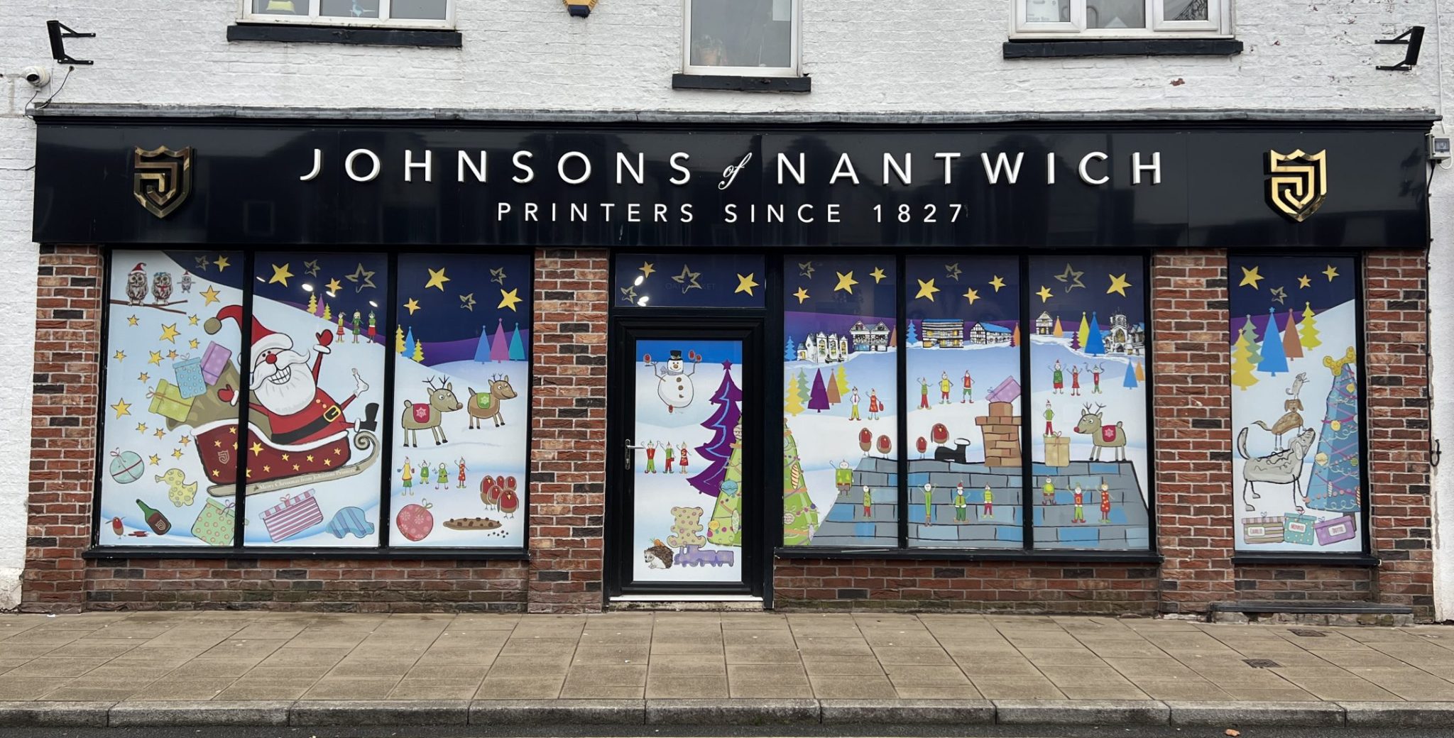 Johnsons in Nantwich installs Christmas window graphics with help from ...